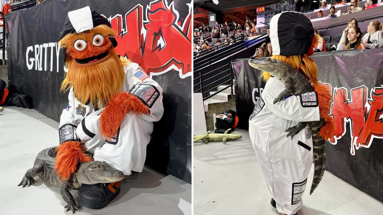 Gritty holds up emotional support alligator Wally during Flyers game ...